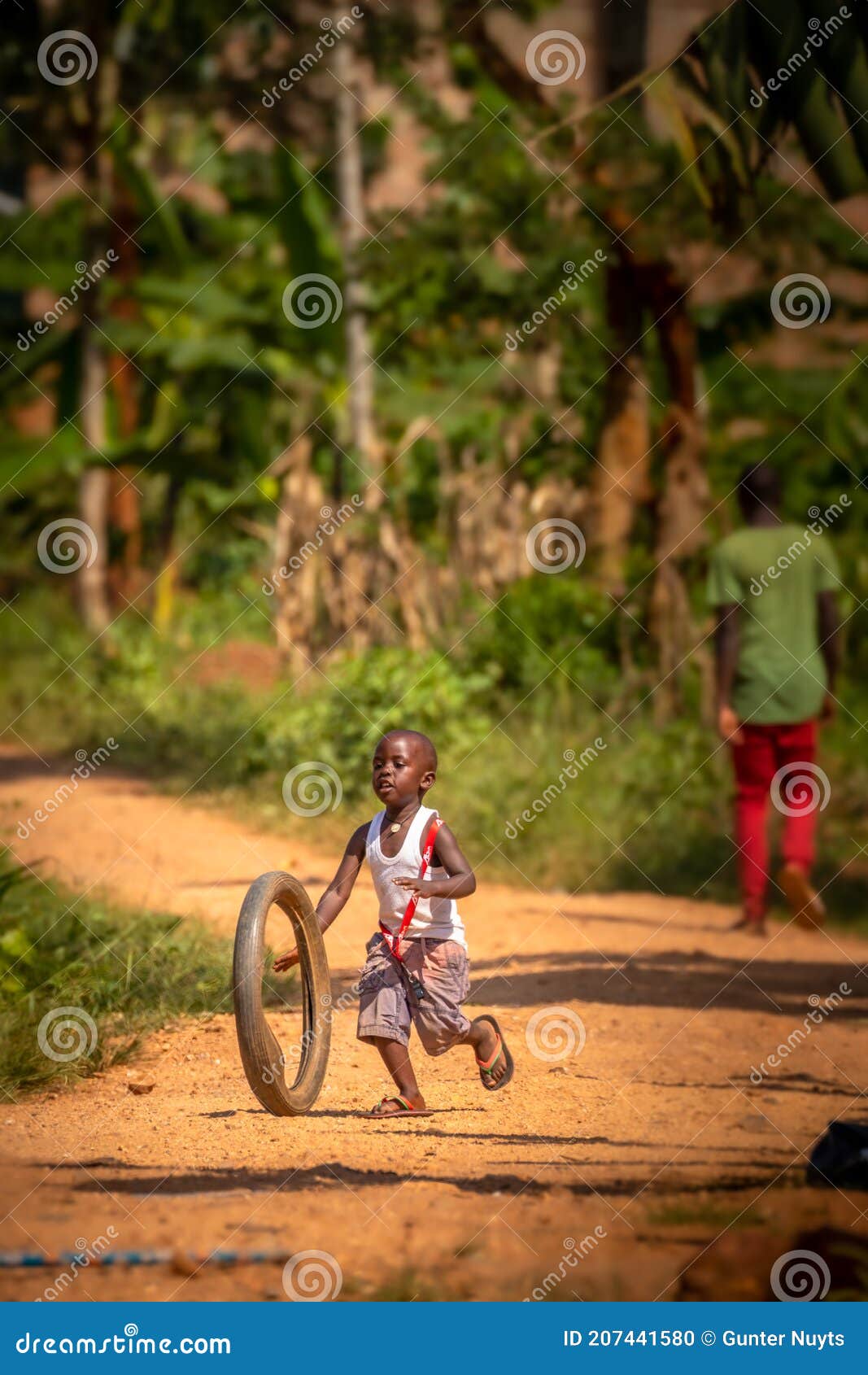 Child Playing with a Tire in Uganda. Editorial Image - Image of game ...