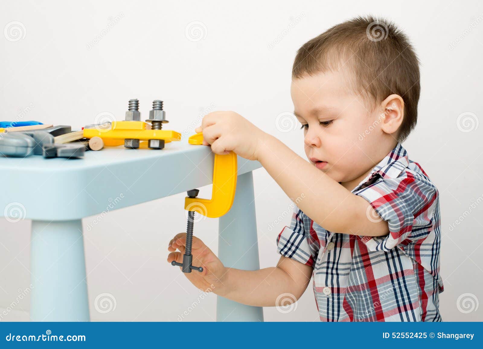 Child playing in tools stock image. Image of playing - 52552425