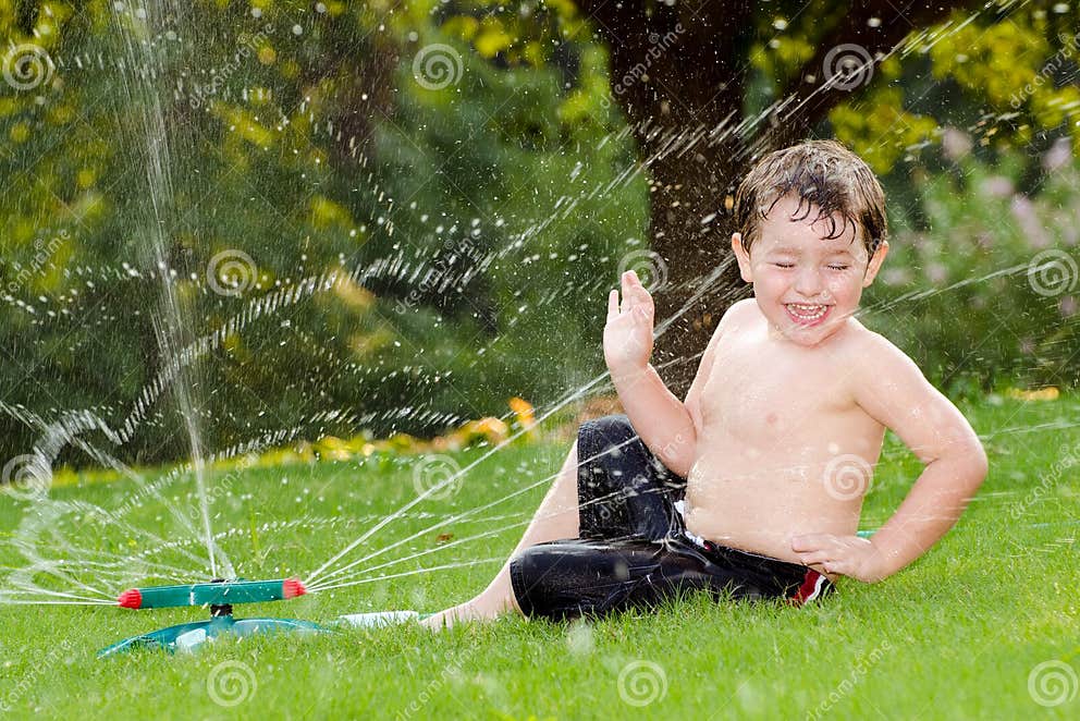 Child Playing in Water Sprinkler Stock Image - Image of water, spray ...