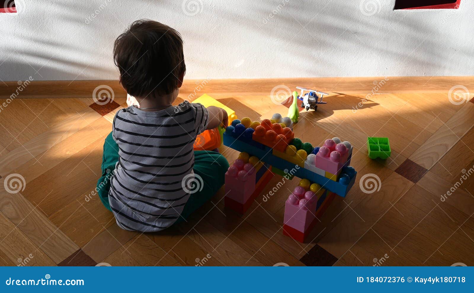 A Child Plays Alone at Home Stock Photo - Image of childhood, brick ...