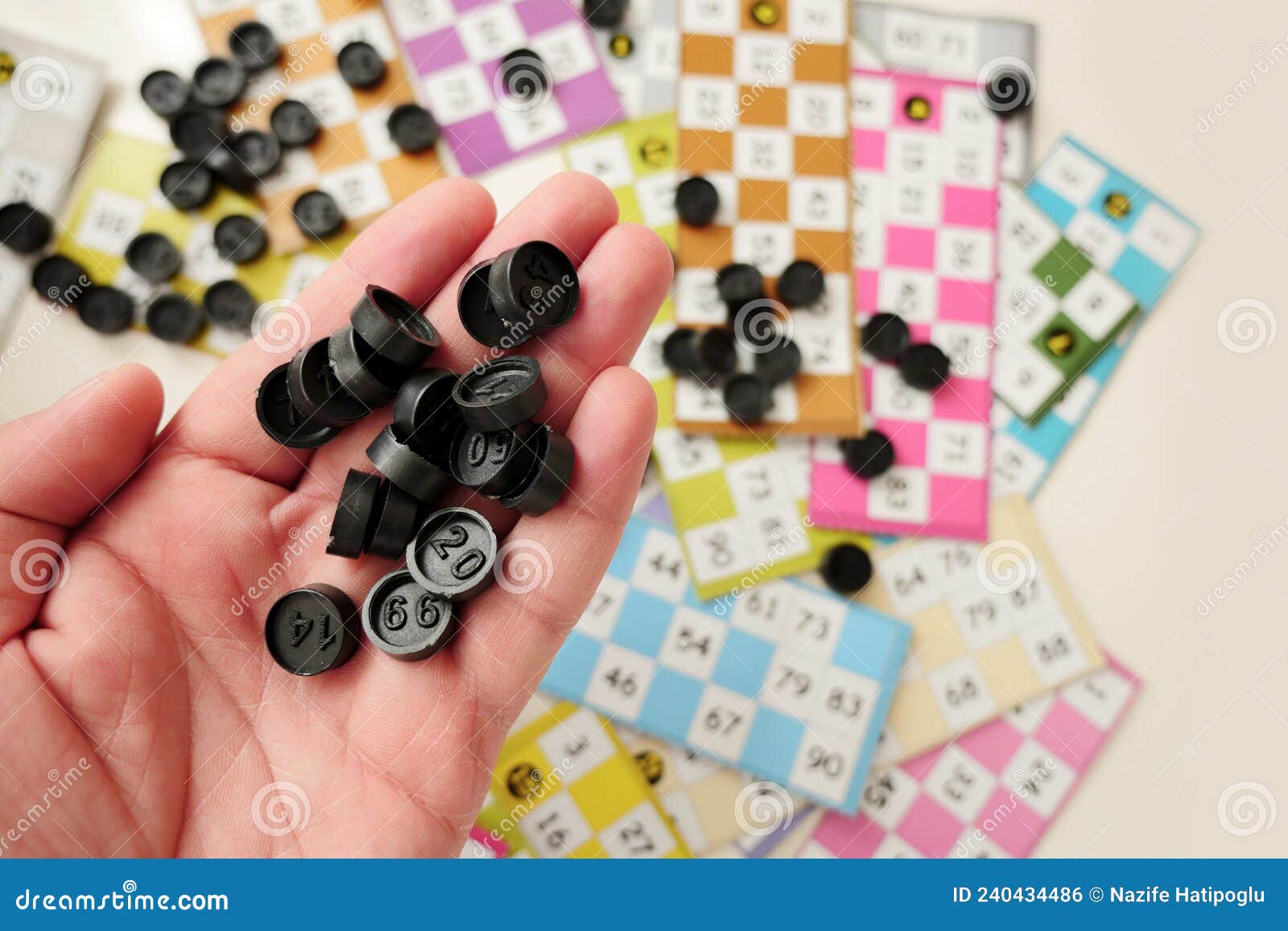 A Child Plays with Bingo Pieces,close-up a Hand Holds Bingo Pieces ...