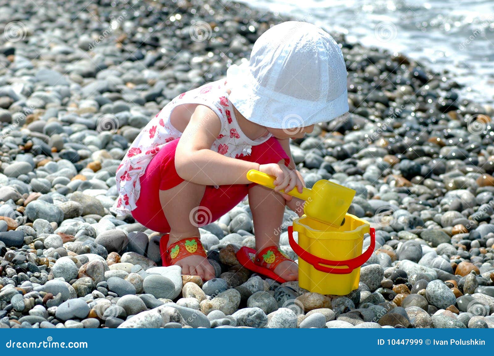 Child plays with a bucket stock image. Image of offspring - 10447999