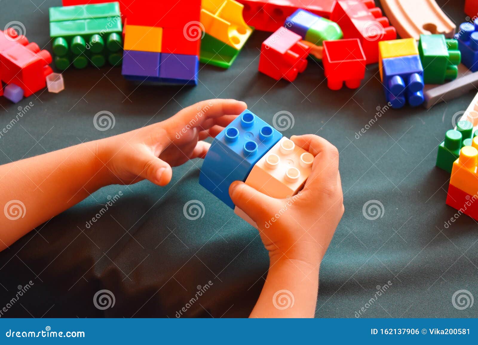 A Child Plays with Colored Cubes. Children`s Plastic Multi-colored ...