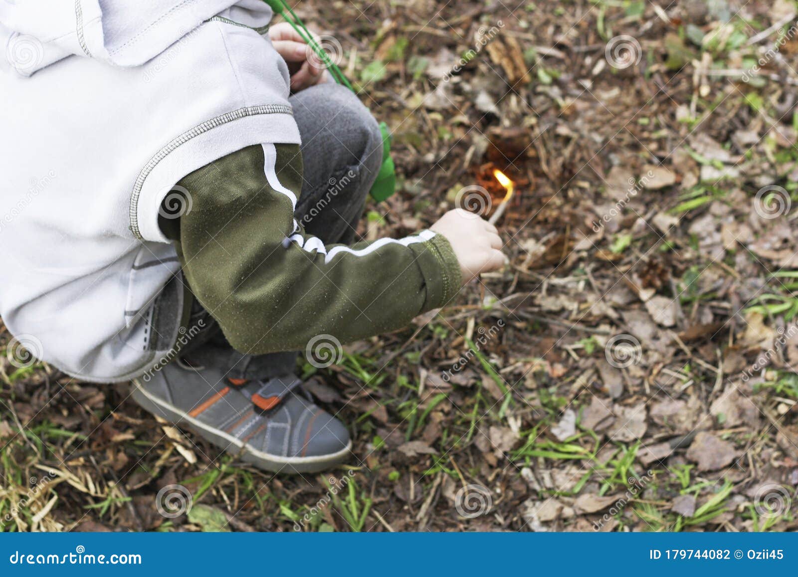 A Child Plays with Fire in the Forest Stock Photo - Image of fire ...