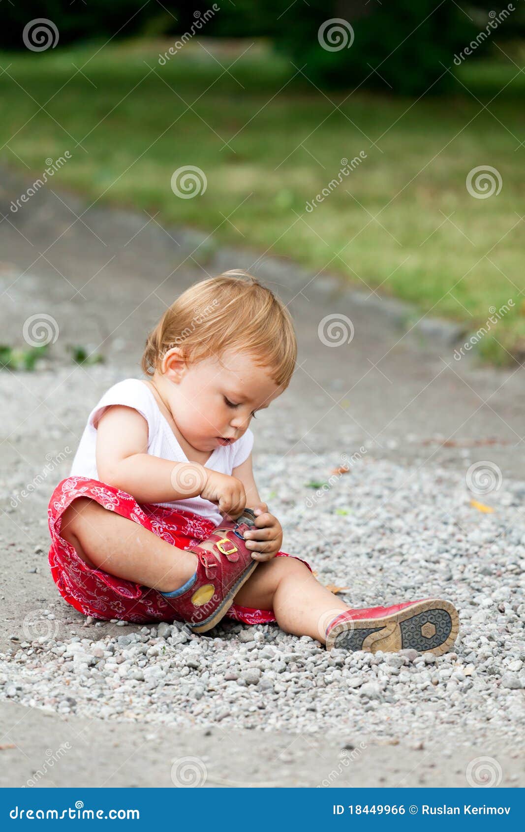 Child plays with pebbles stock photo. Image of play, interest - 18449966
