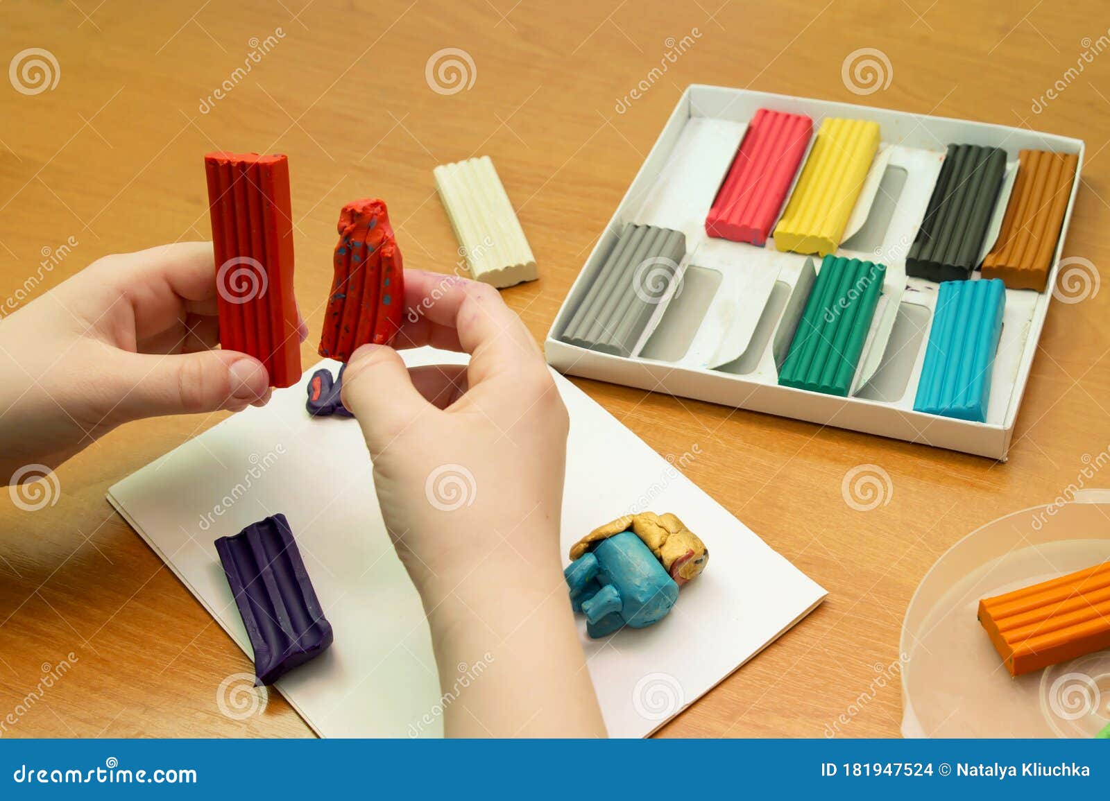 A Child Plays with Plasticine. Multi-colored Plasticine on the Table ...