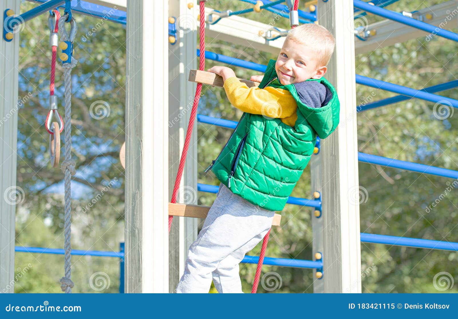 The Child Plays in the Playground, Climbs the Stairs. Stock Image ...