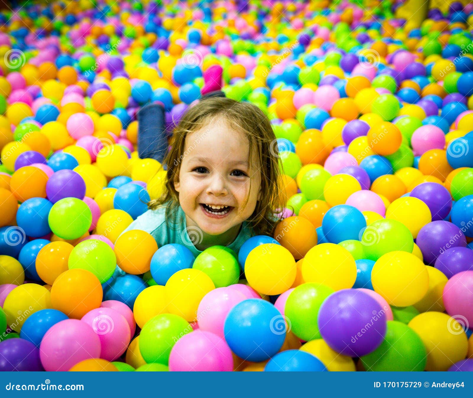 Child Plays in the Pool with Balls. One Head Sticks Out Stock Image ...