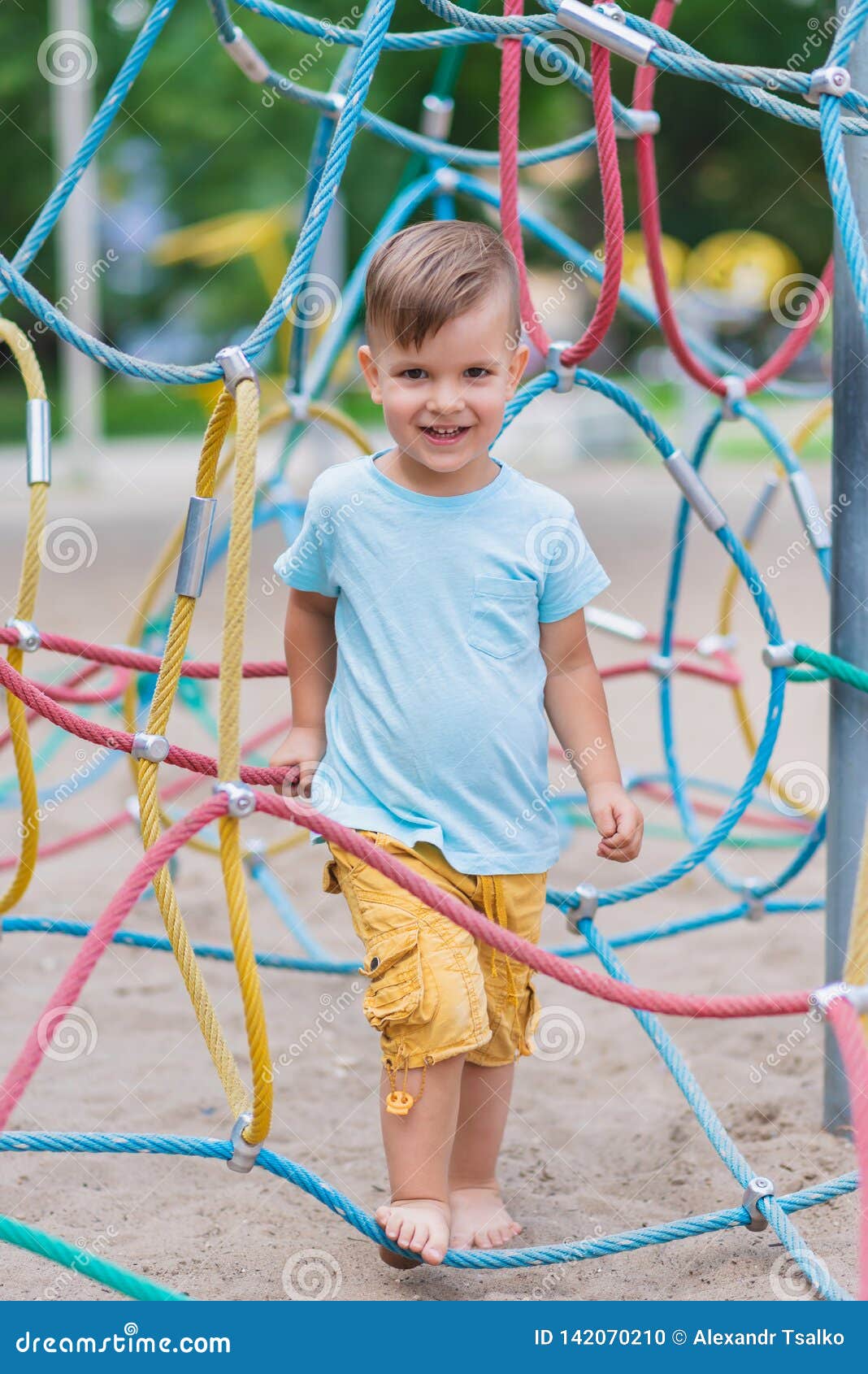 A Child Plays in a Rope Web on the Playground in the Park Stock Photo ...