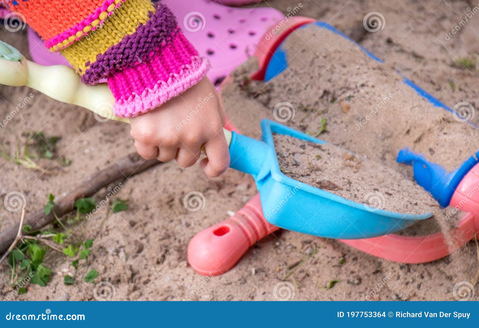 Child playing in the sand stock photo. Image of resource - 197753364