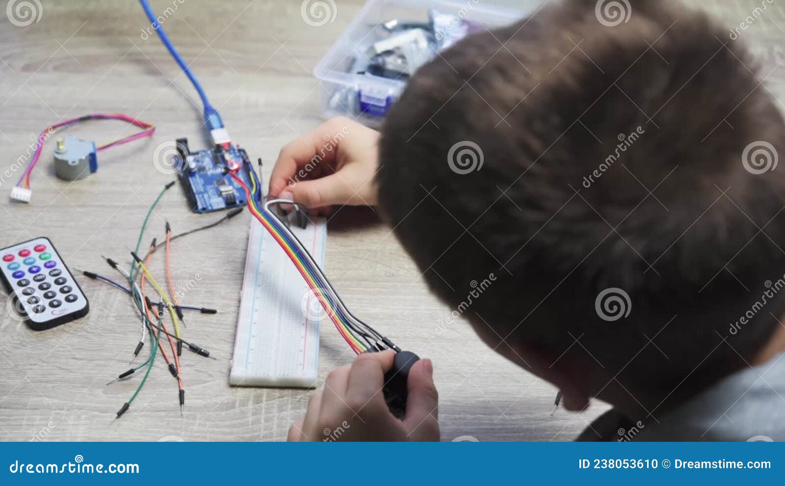 A Child Plugging Cables To Sensor Chips while Learning Arduino Coding and Robotics Stock Footage ...