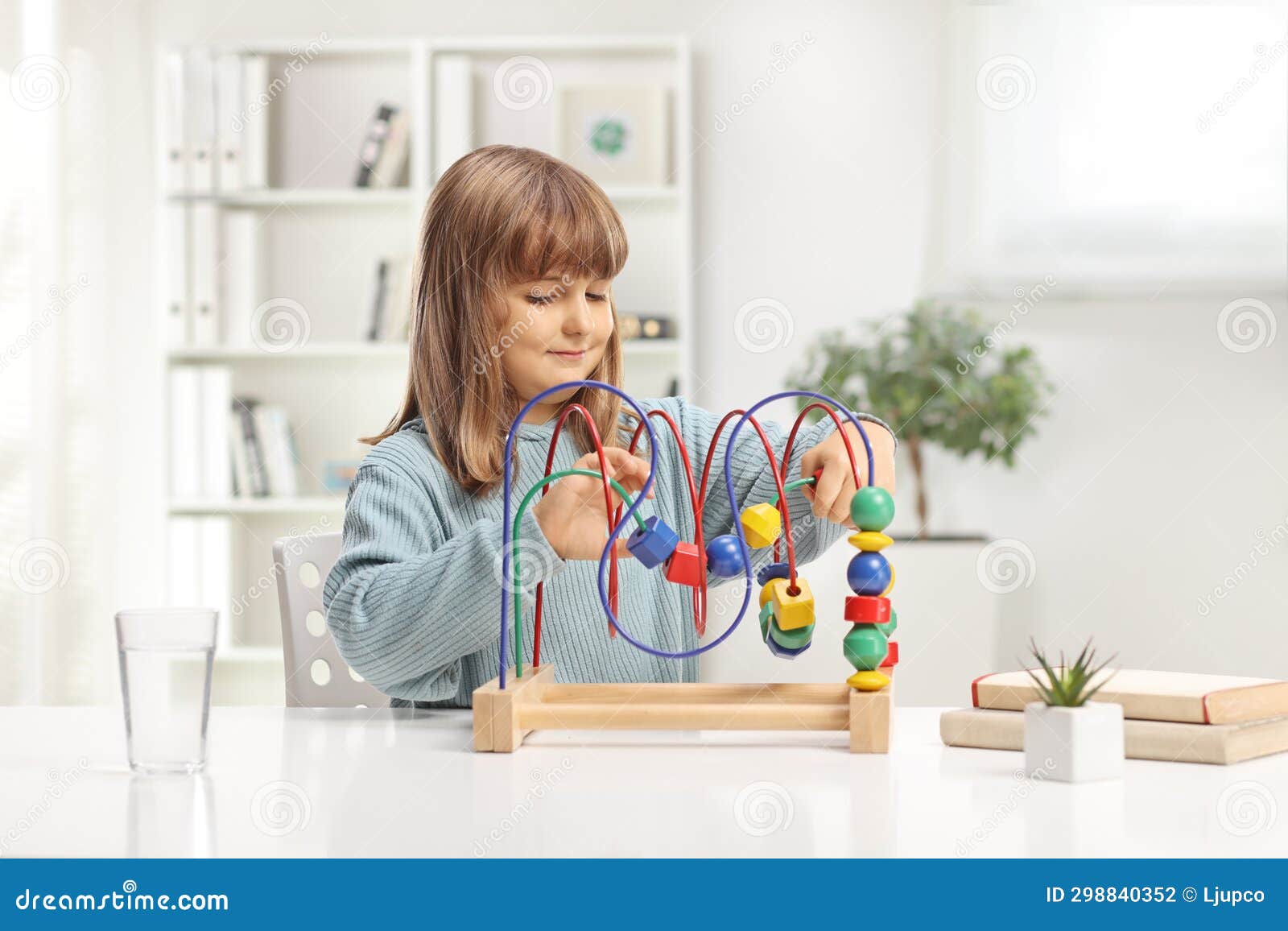 Child Practicing Motor Skills with a Toy Stock Photo - Image of girl ...