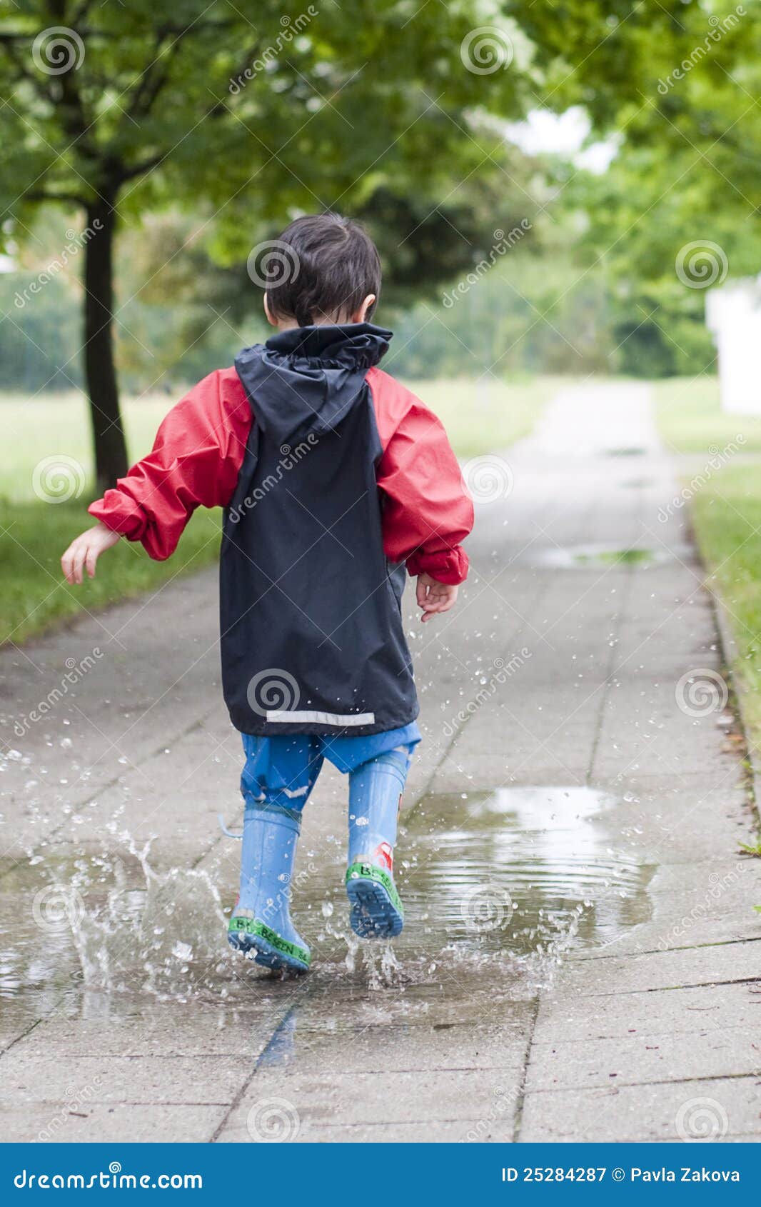 Child in puddle stock image. Image of child, drops, coat - 25284287