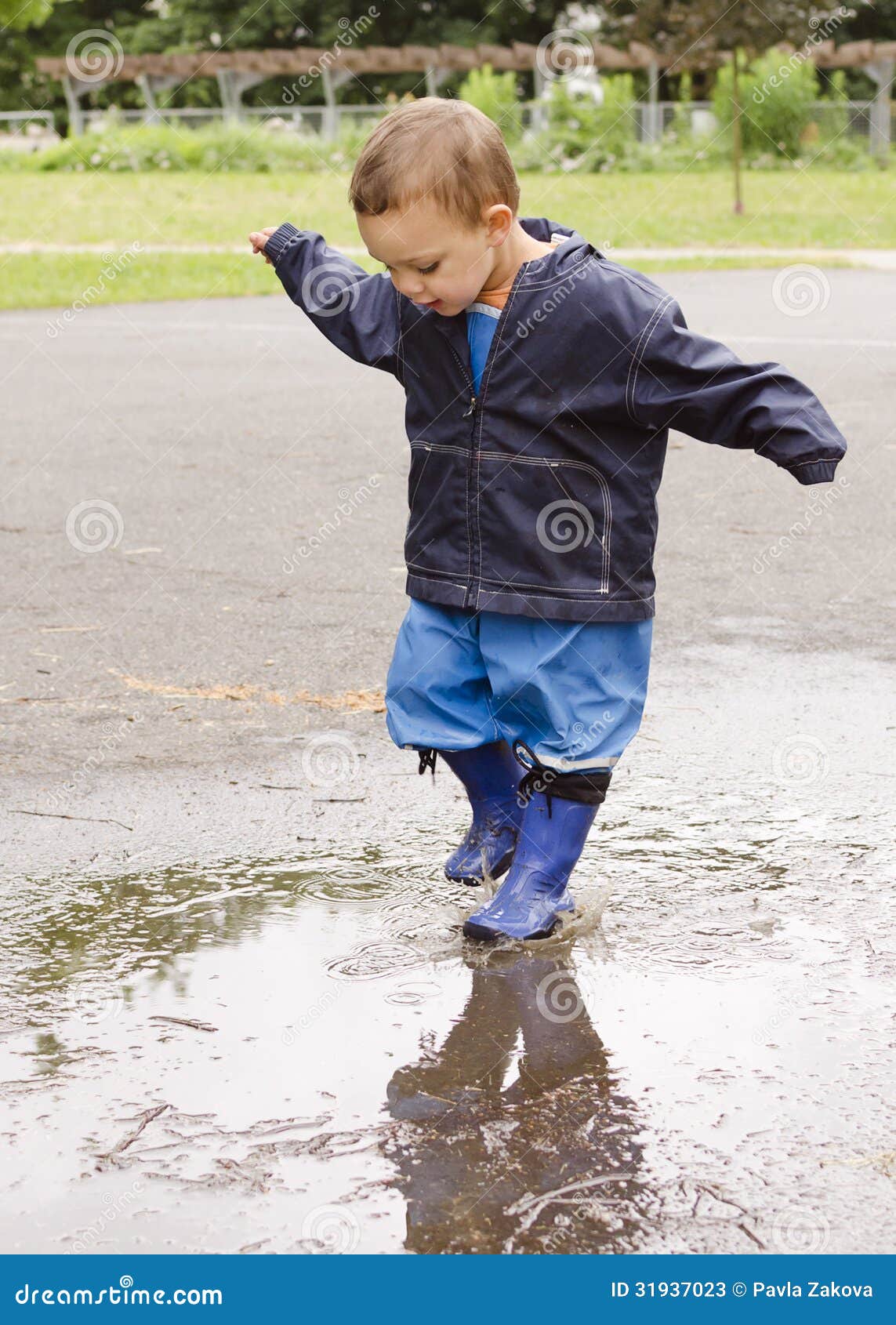 Child in puddle stock image. Image of smiling, rainboots - 31937023
