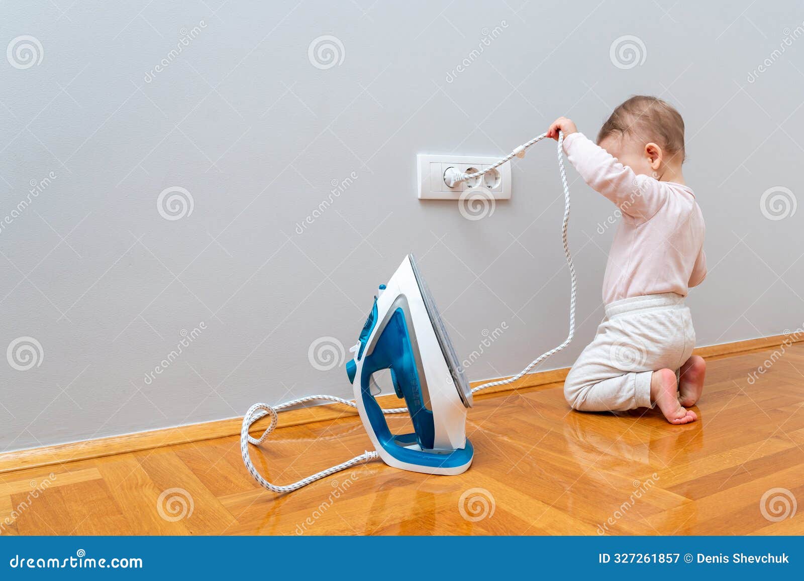 The Child Pulls the Electrical Plug Out of the Socket To Let the Iron ...