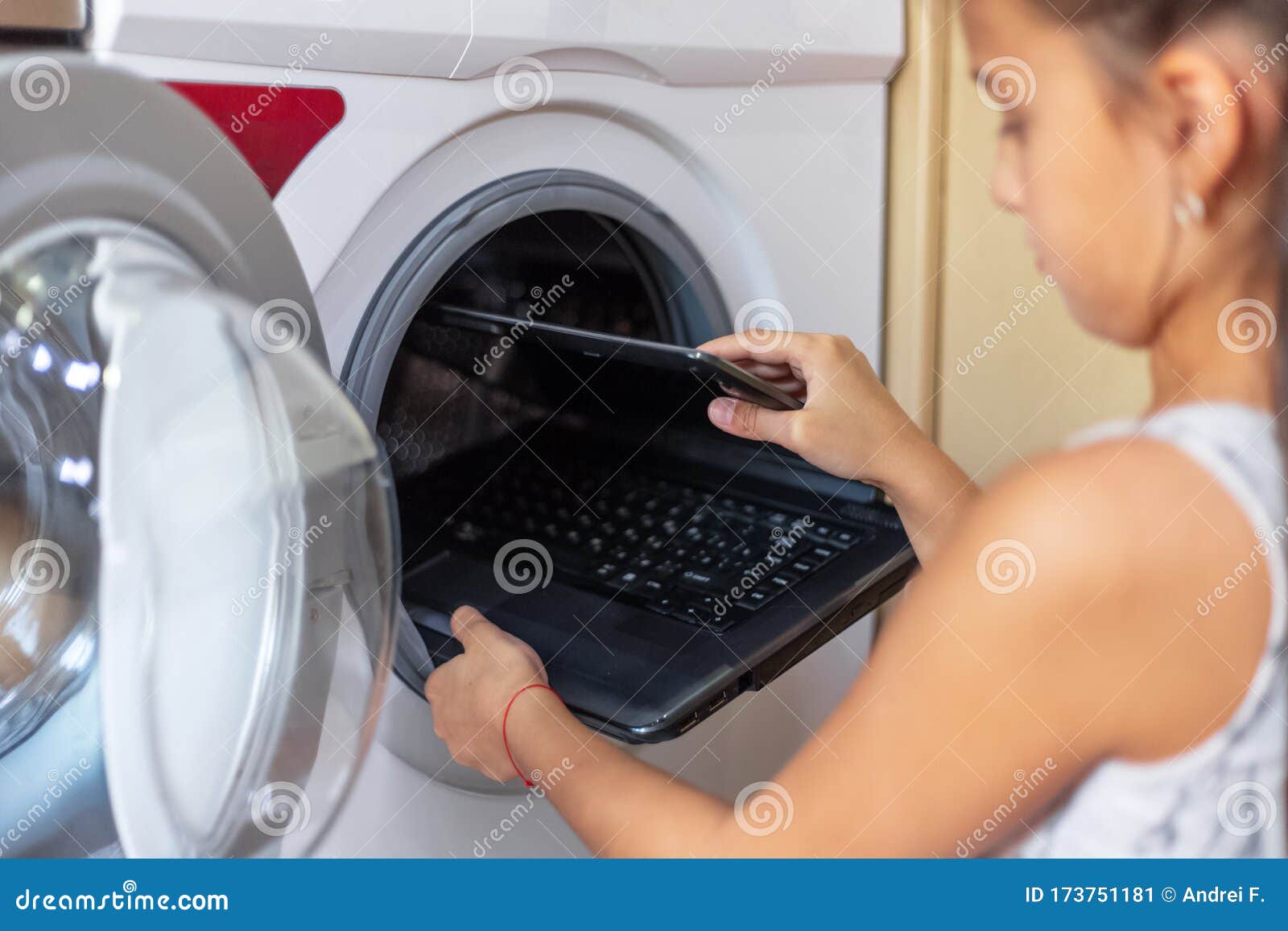 A Child Put a Laptop in Washing Machine. Stock Image - Image of ...