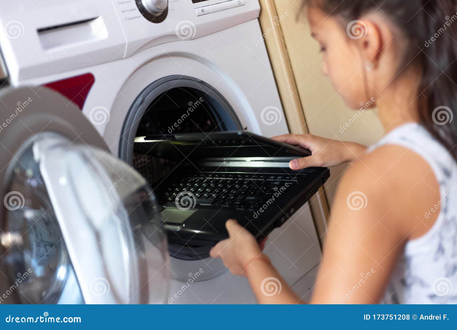A Child Put a Laptop in Washing Machine. Stock Photo - Image of laundry ...