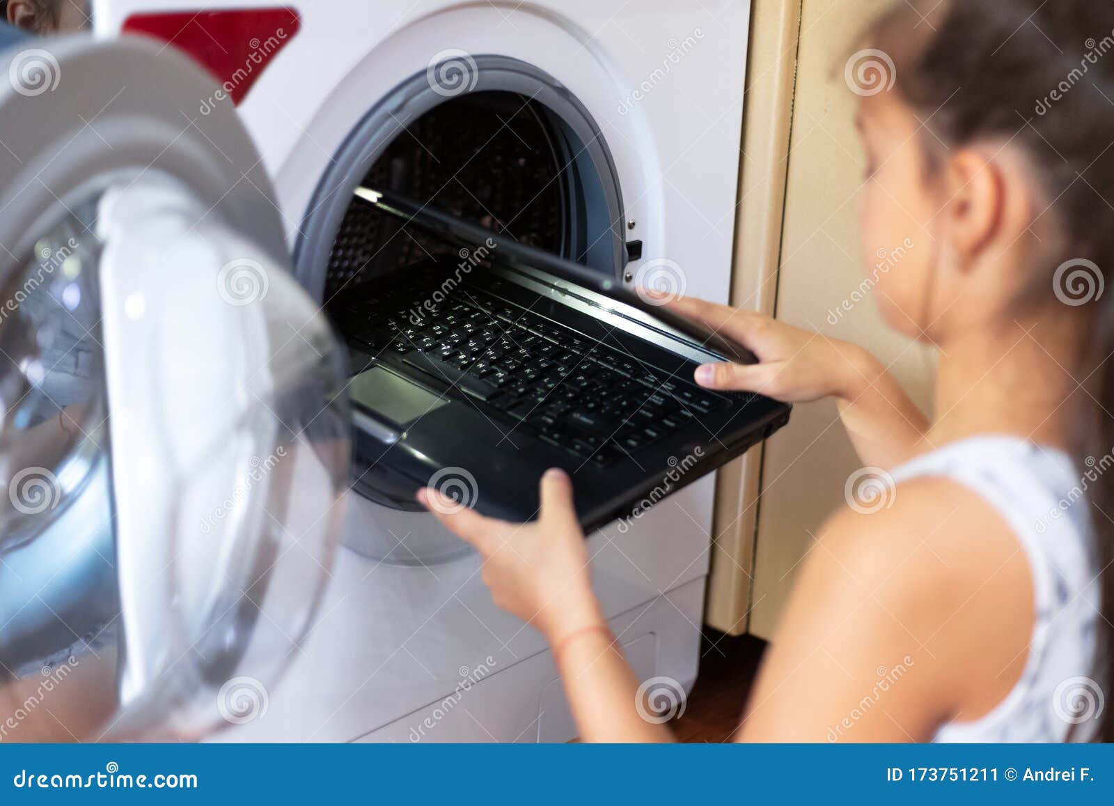 A Child Put a Laptop in Washing Machine. Stock Image - Image of female ...