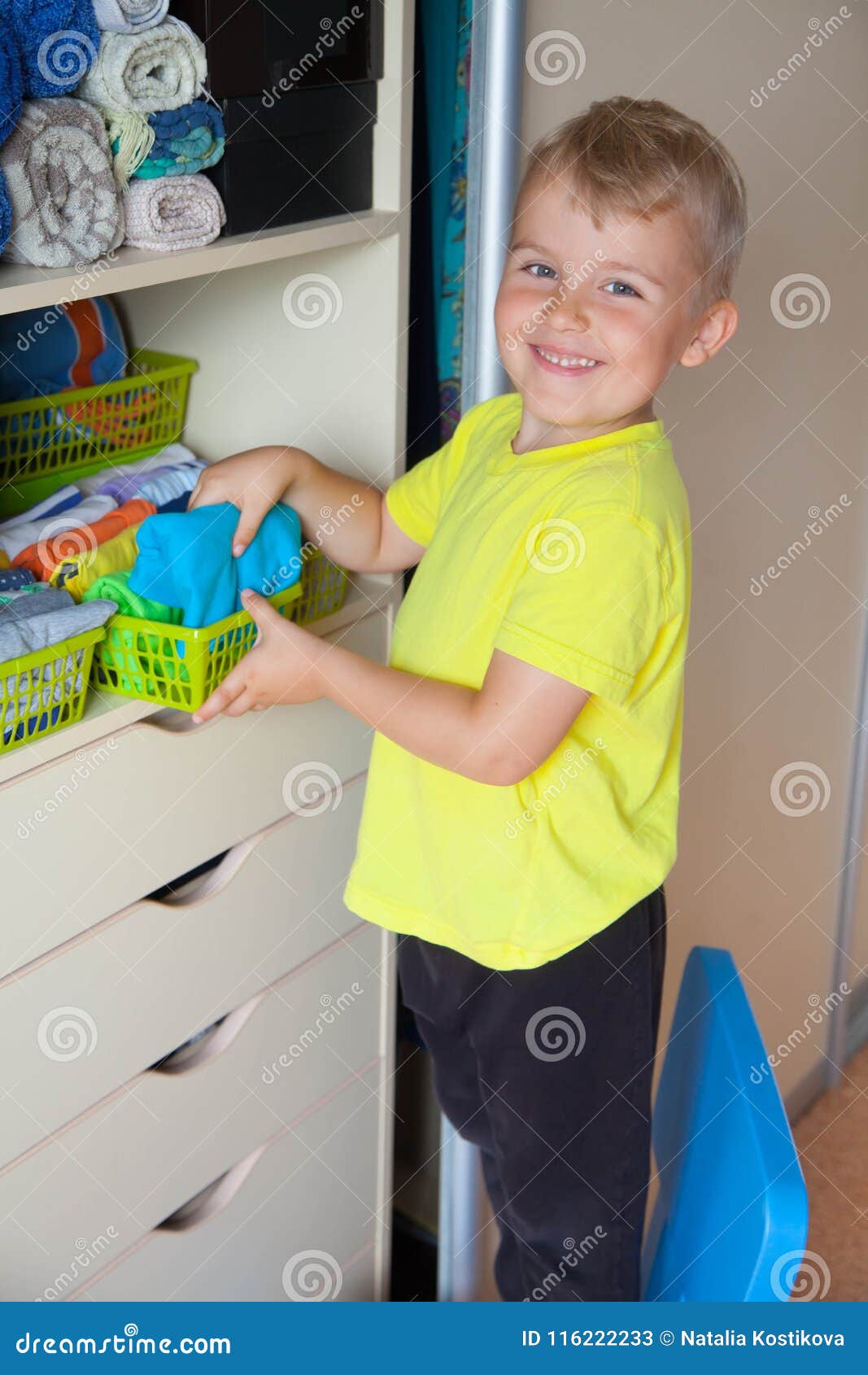 The Child Puts His Clothes on. the Boy Pulls the T-shirt Out of Stock ...