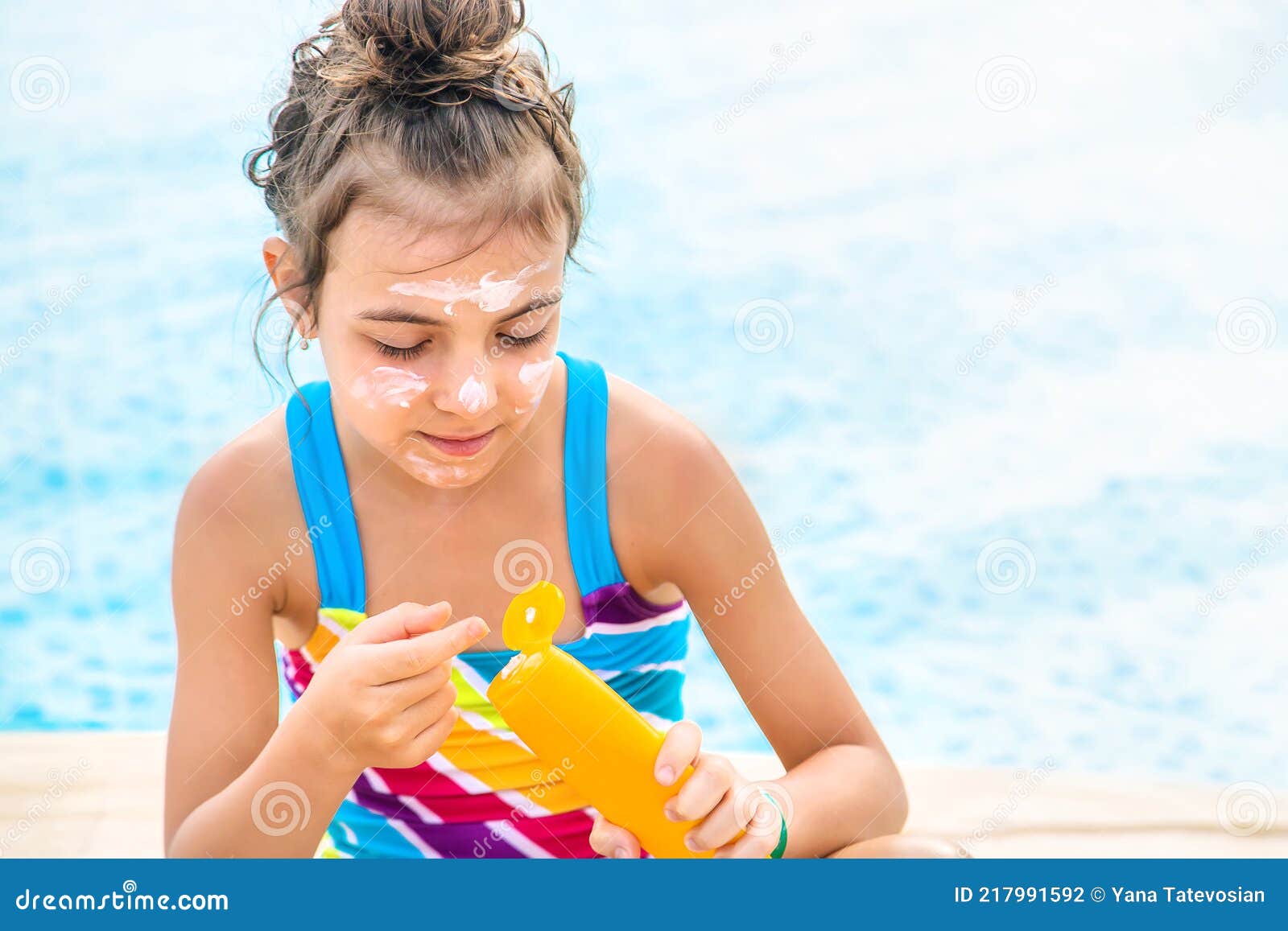 The Child is Putting on Sunscreen. Selective Focus Stock Photo - Image ...