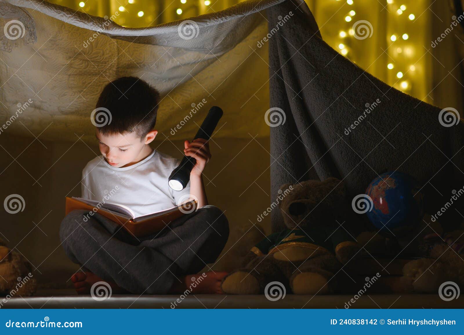 The Child is Reading a Book with a Flashlight Stock Photo - Image of ...