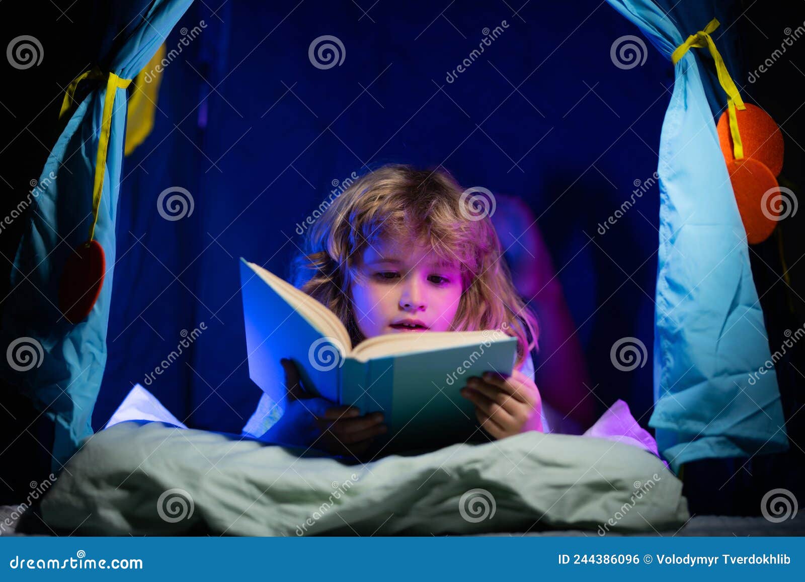 Child Reading Book. Kids Bedtime. Boy Read Book in Bed. Stock Photo ...
