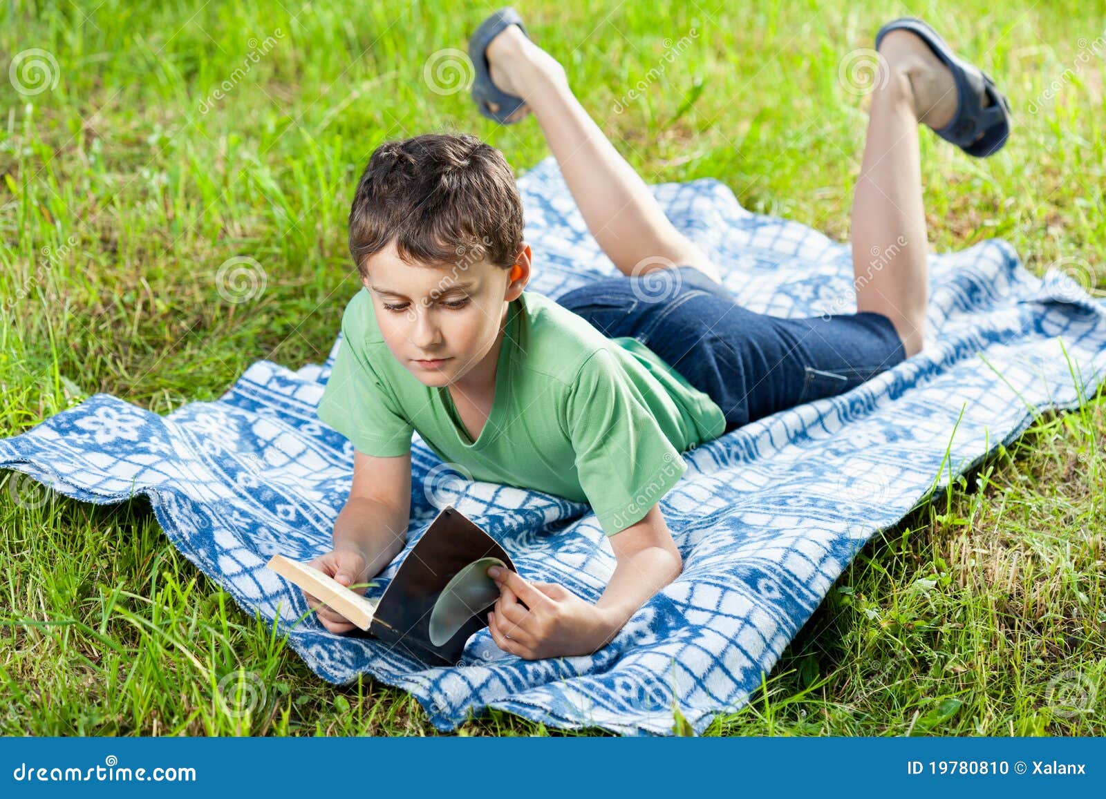 Child Reading a Book Outdoor Stock Photo - Image of focused, grass ...
