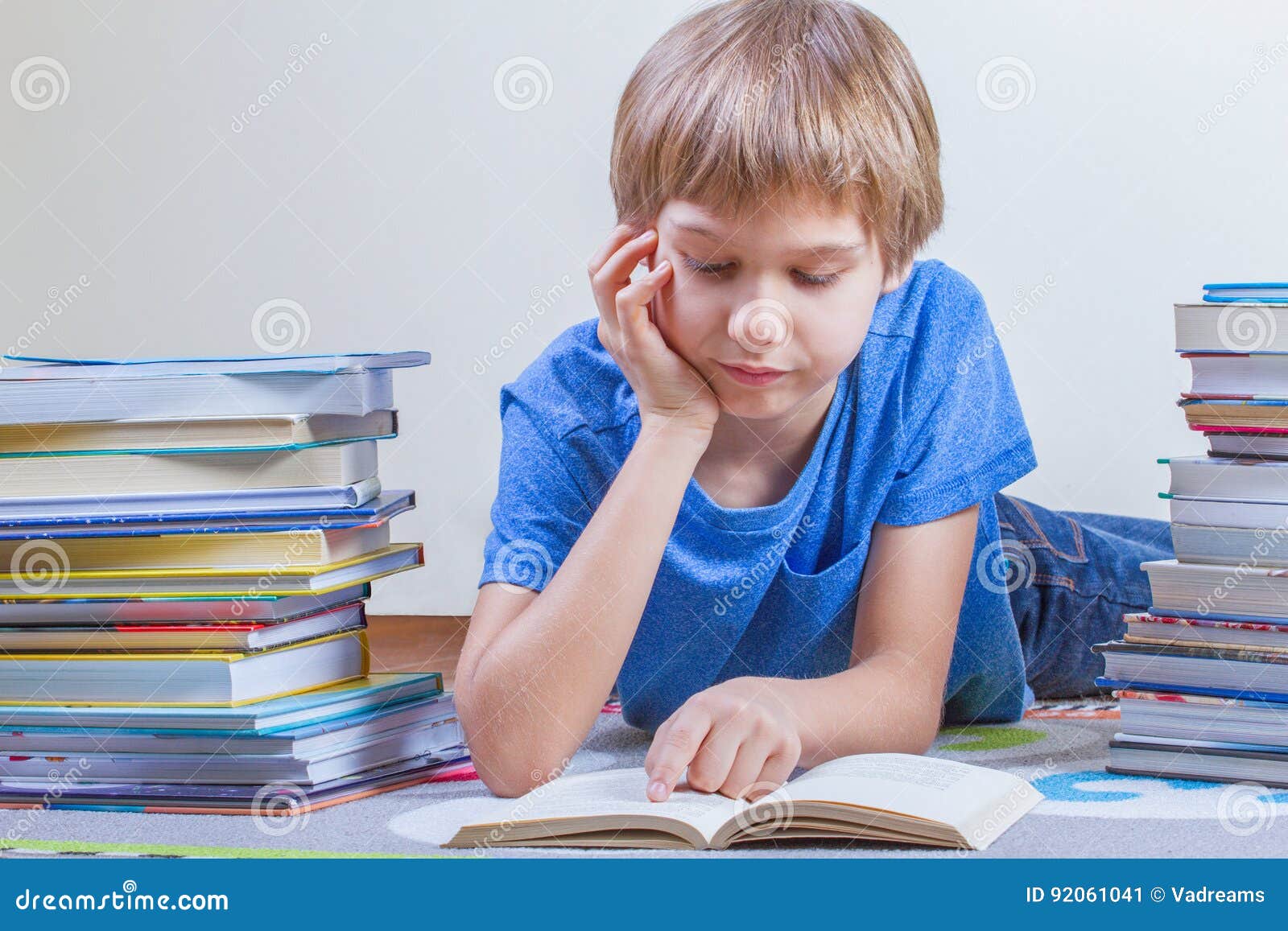 Child Reading Book between the Stacks of Books. Stock Image - Image of ...