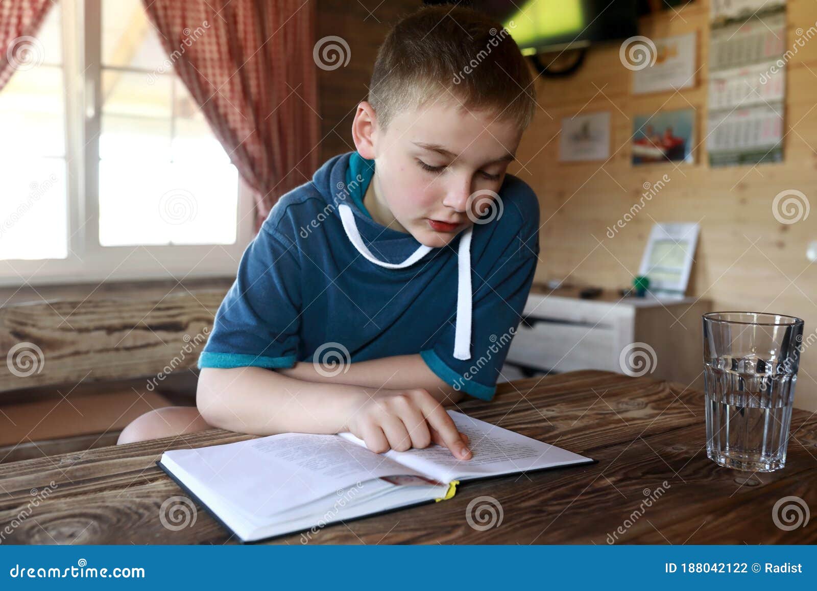 Child Reading Book at Table Stock Photo - Image of hand, looking: 188042122
