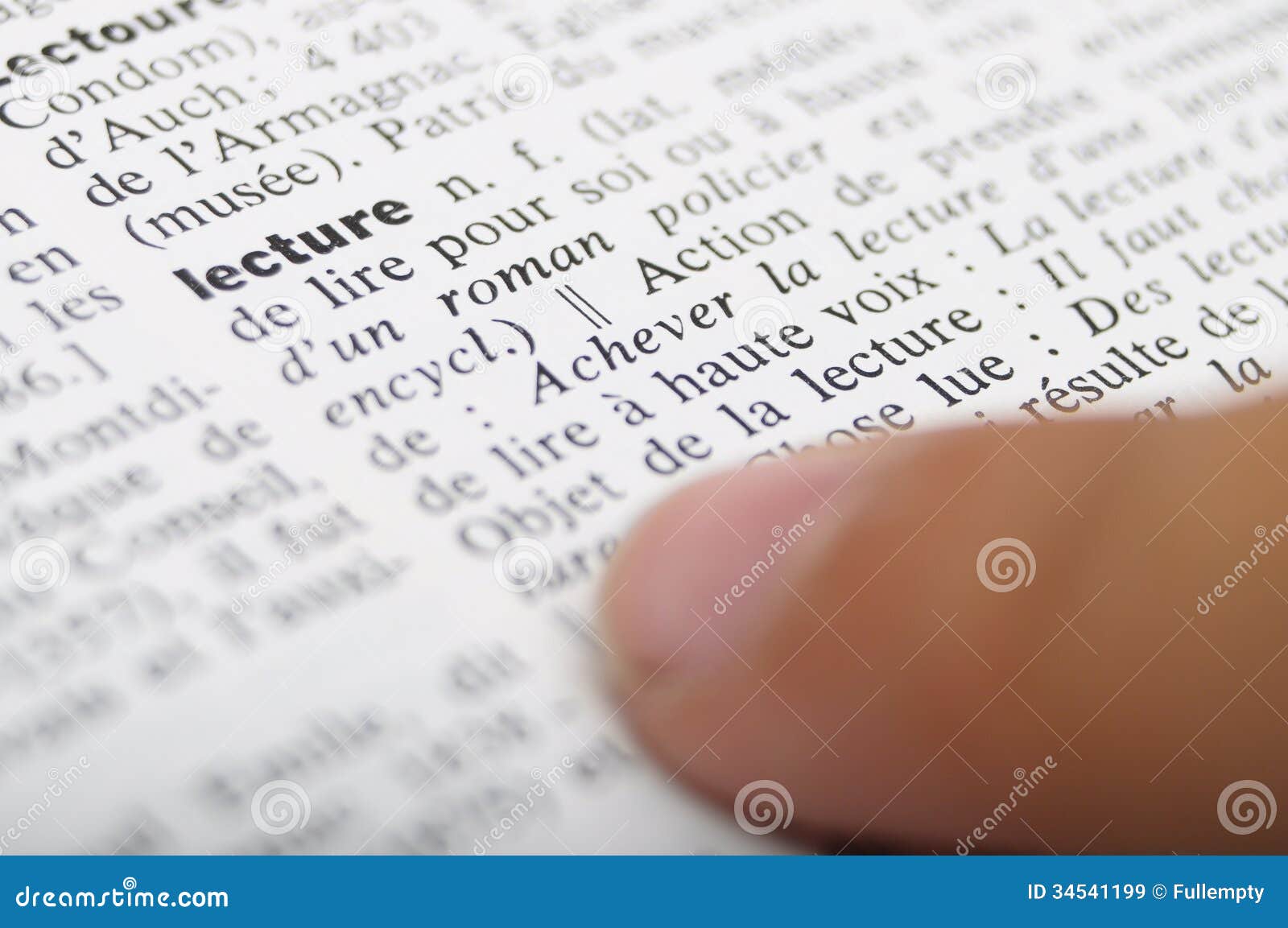 Child Reading with His Finger on Dictionary Stock Image - Image of blur ...