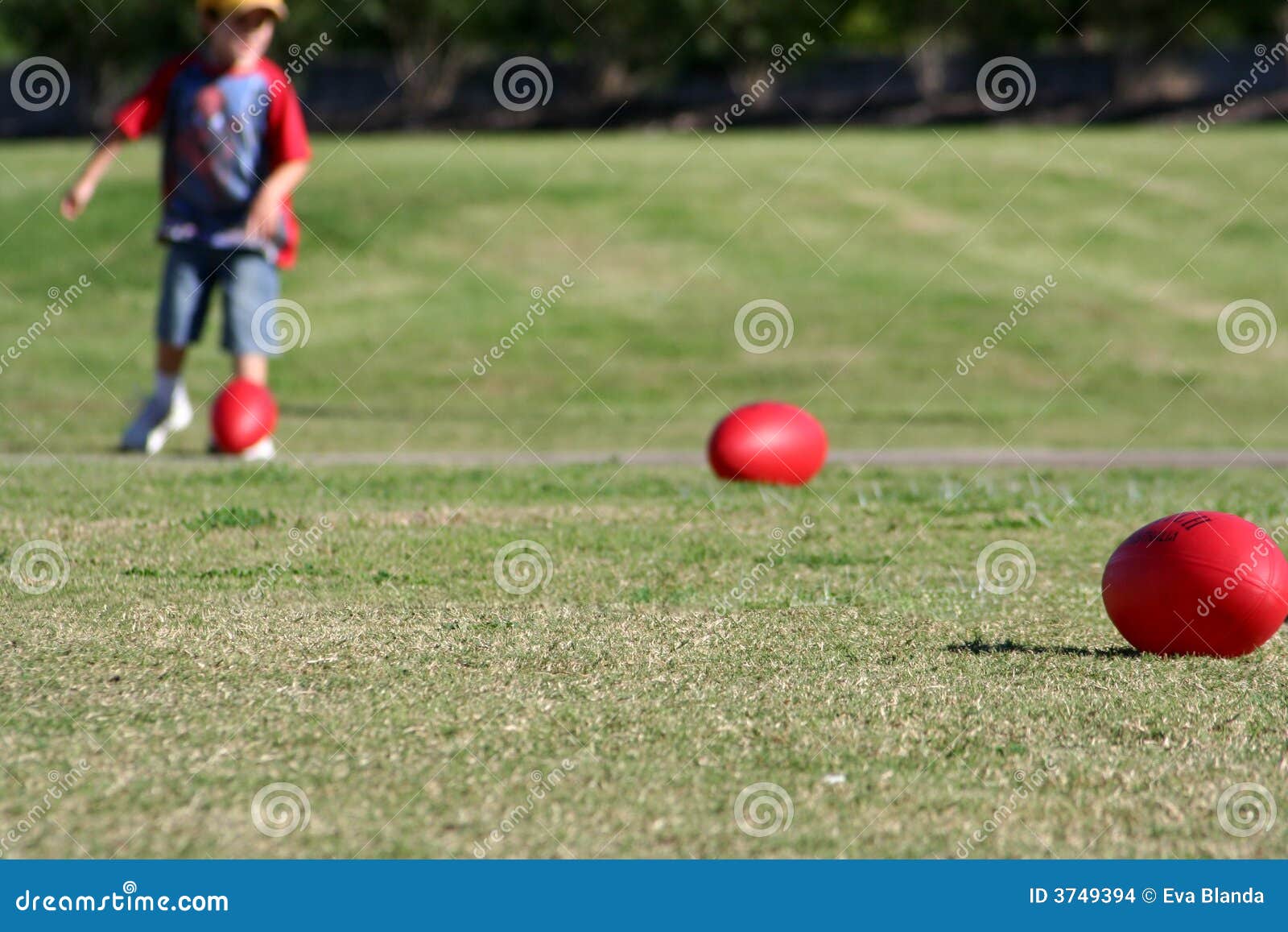 Child with red rugby balls stock photo. Image of field - 3749394