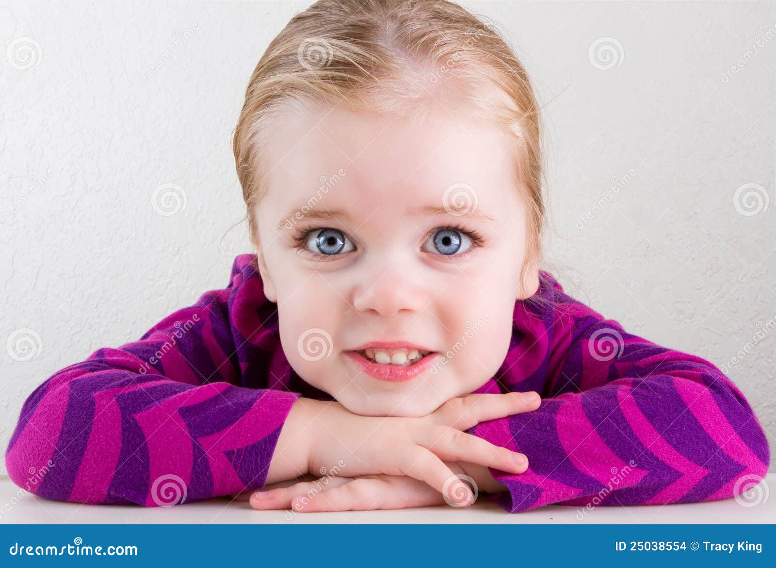 Child Resting Her Head on Her Hands Smiling Stock Photo - Image of ...