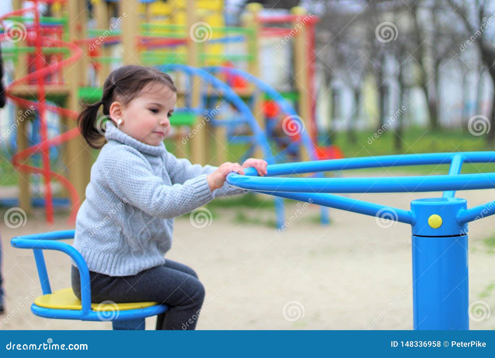 Child Rides on the Carousel in the Playground Stock Photo - Image of ...