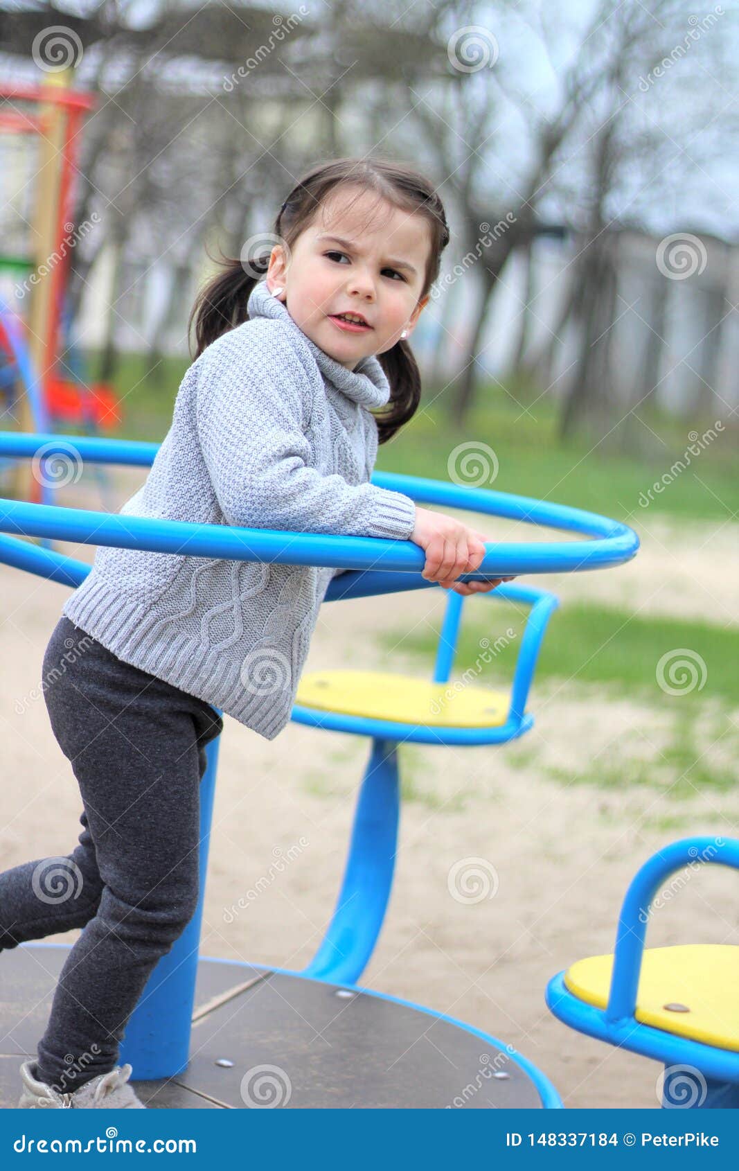 Child Rides on the Carousel in the Playground Stock Photo - Image of ...