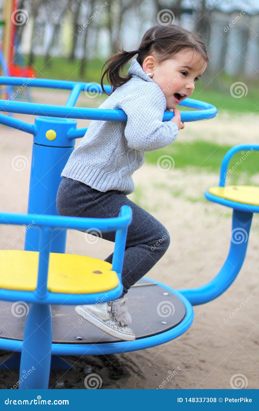 Child Rides on the Carousel in the Playground Stock Photo - Image of ...