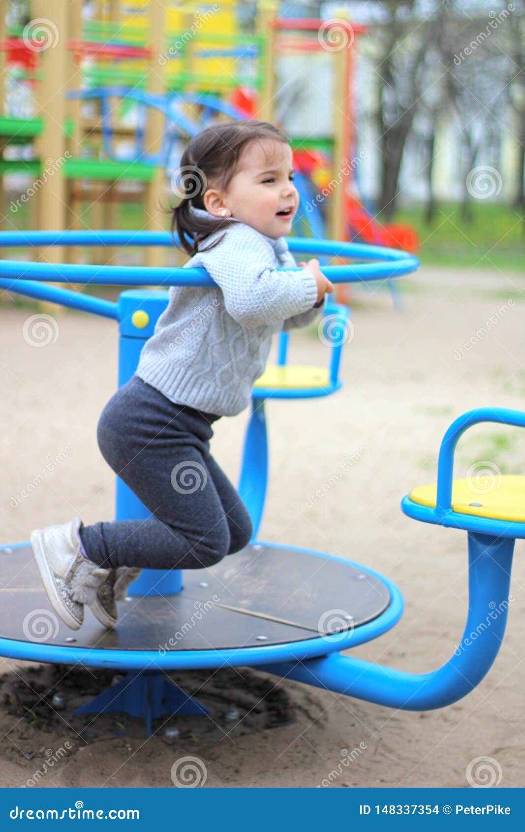 Child Rides on the Carousel in the Playground Stock Photo - Image of ...