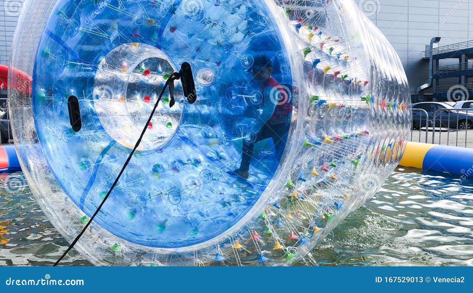 A Child Rides in an Inflatable Transparent Cylinder in the Pool ...