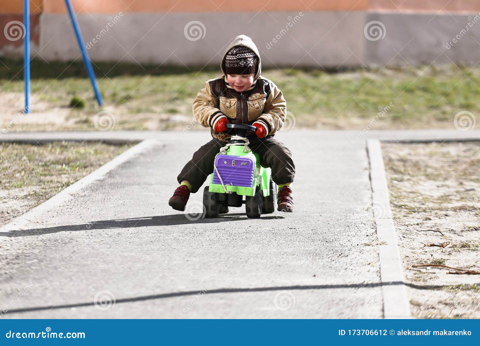 Child Rides a Toy Car in Spring Stock Photo - Image of cheerful, flower ...