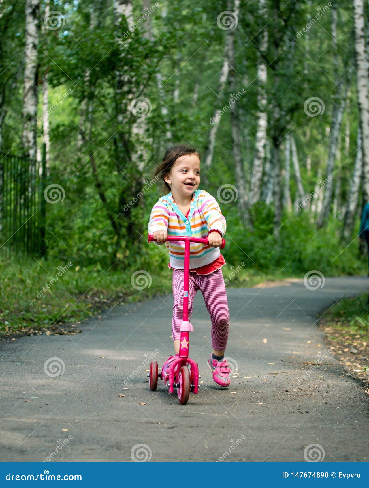 Child riding a scooter stock photo. Image of play, leisure - 147674890