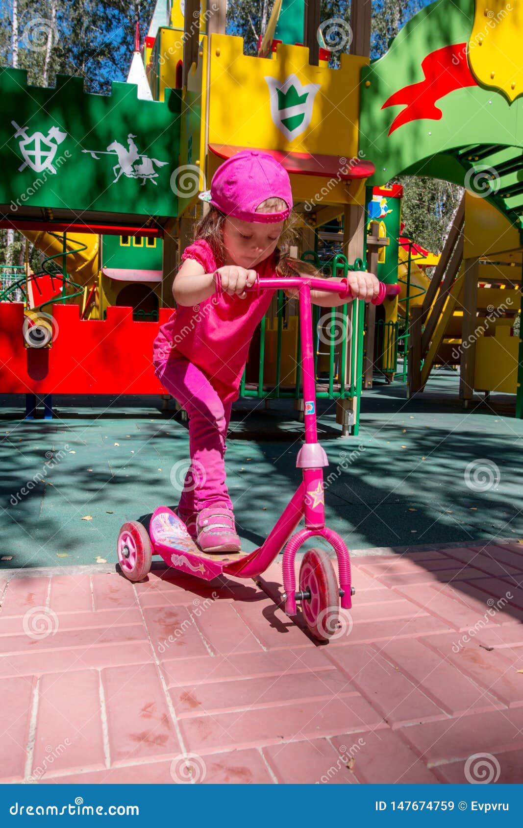 Child riding a scooter stock image. Image of person - 147674759