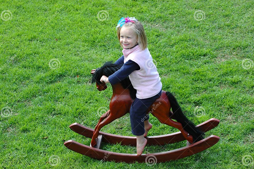 Child on rocking-horse stock image. Image of happiness - 3290837