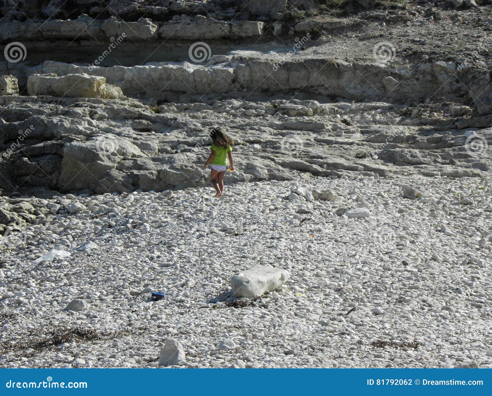 Child on the rocks stock photo. Image of cliff, back - 81792062