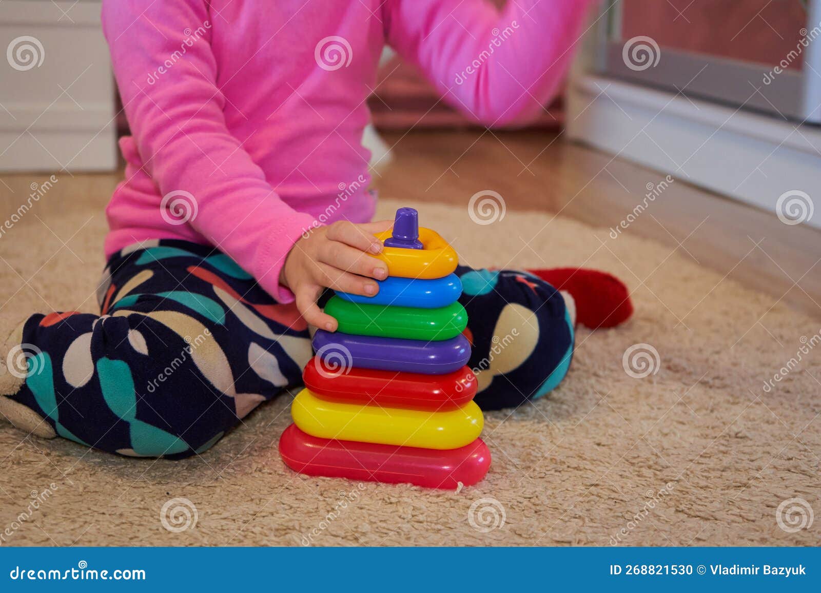 A Child is Playing with a Colored Pyramid,a Child in a Room Playing ...