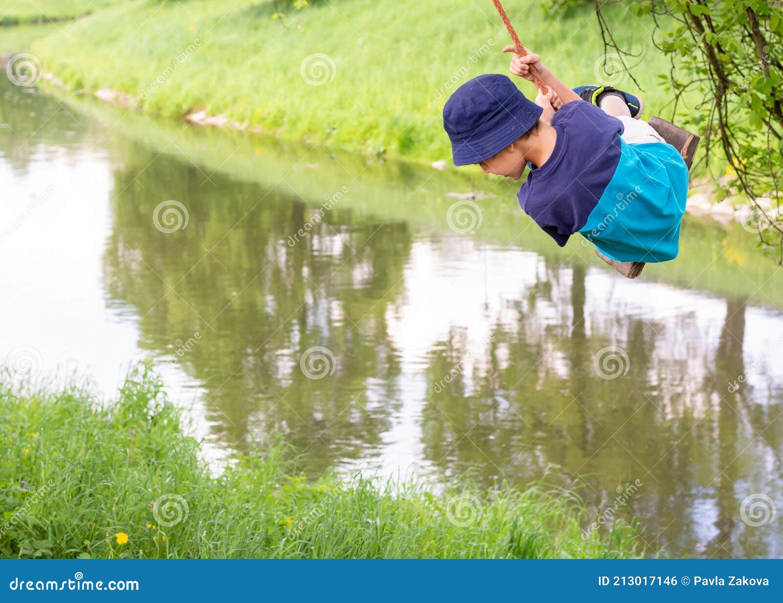 Child on a rope swing stock photo. Image of green, action - 213017146
