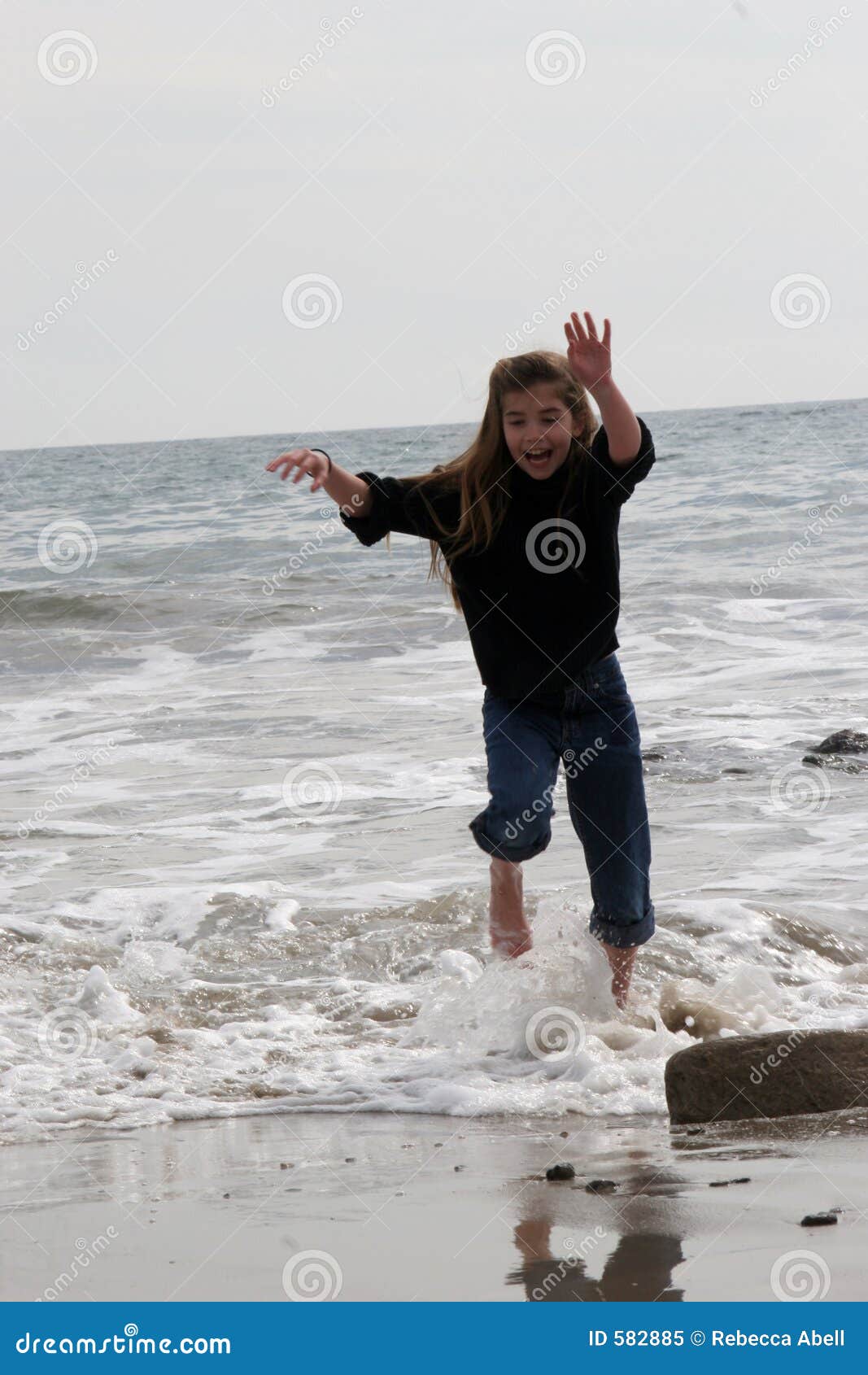 Child Running from the Waves Stock Image - Image of running, laugh: 582885
