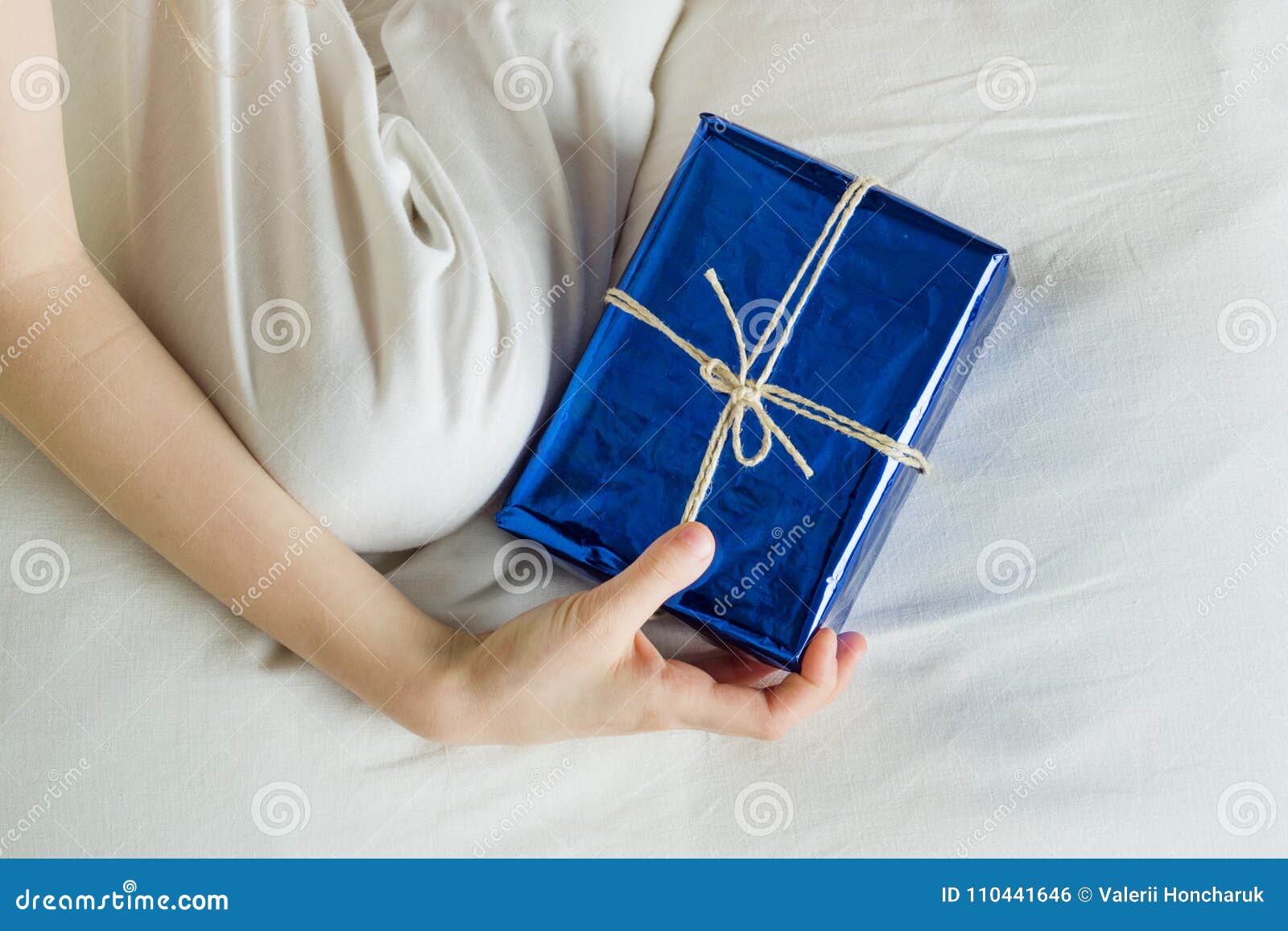 A Child`s Hand in Bed Holds Surprise Gift Stock Photo - Image of ...