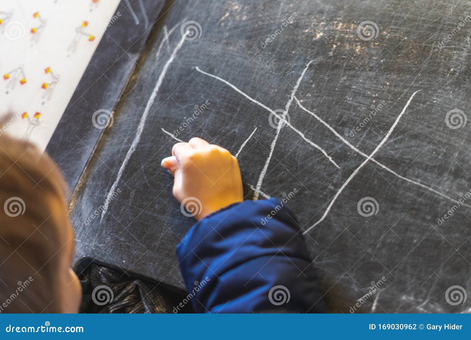 A Child`s Hand Drawing on a Blackboard with Chalk Stock Photo - Image ...