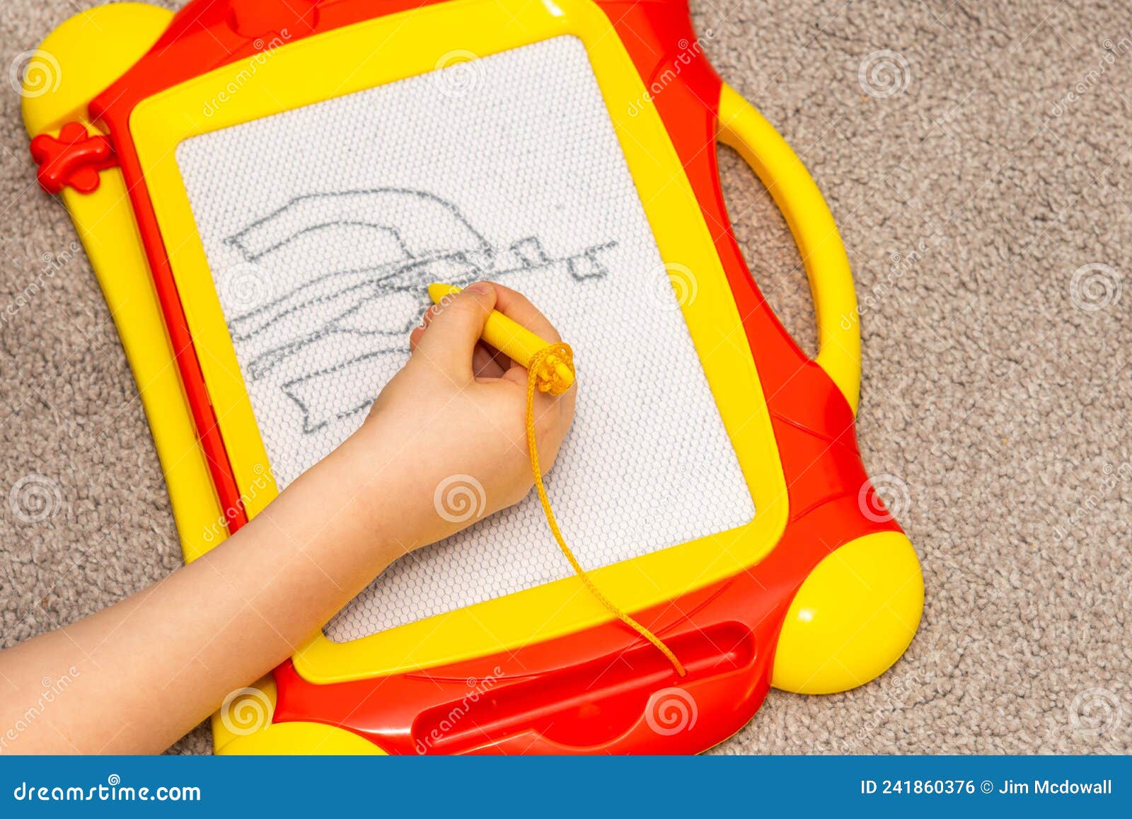 Child`s Hand Drawing on Educational Drawing Board that is Magnetic ...