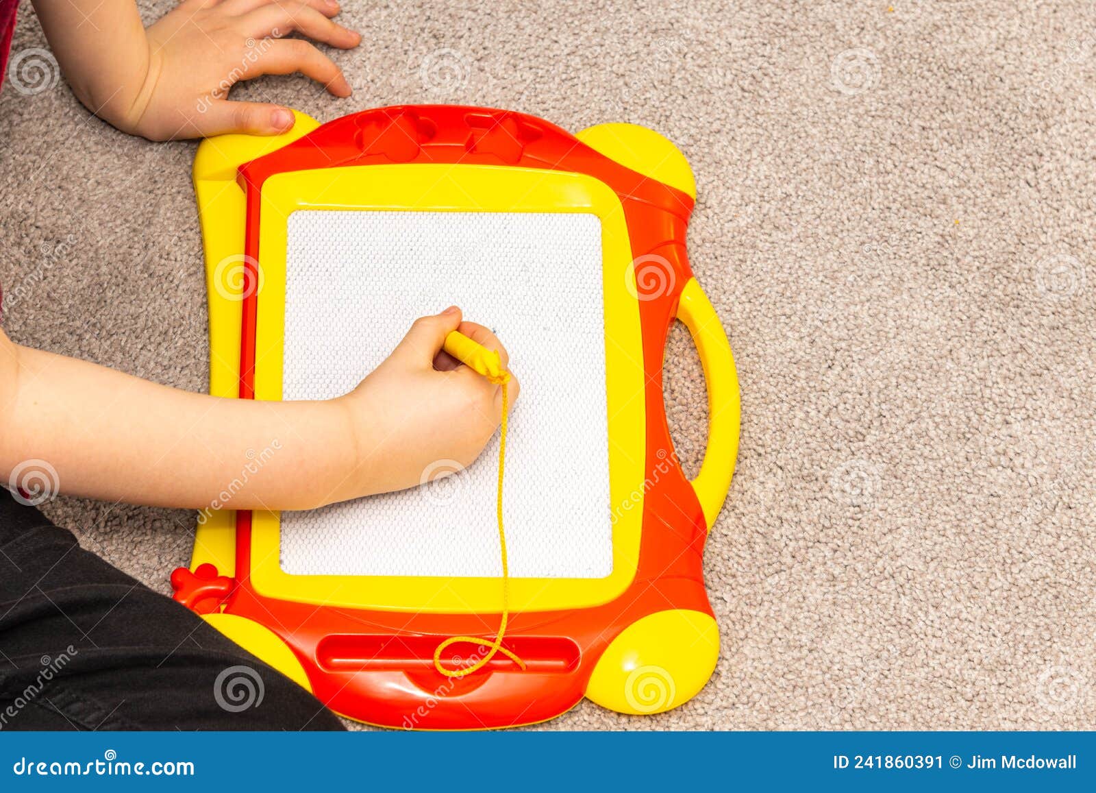 Child`s Hand Drawing on Educational Drawing Board that is Magnetic ...