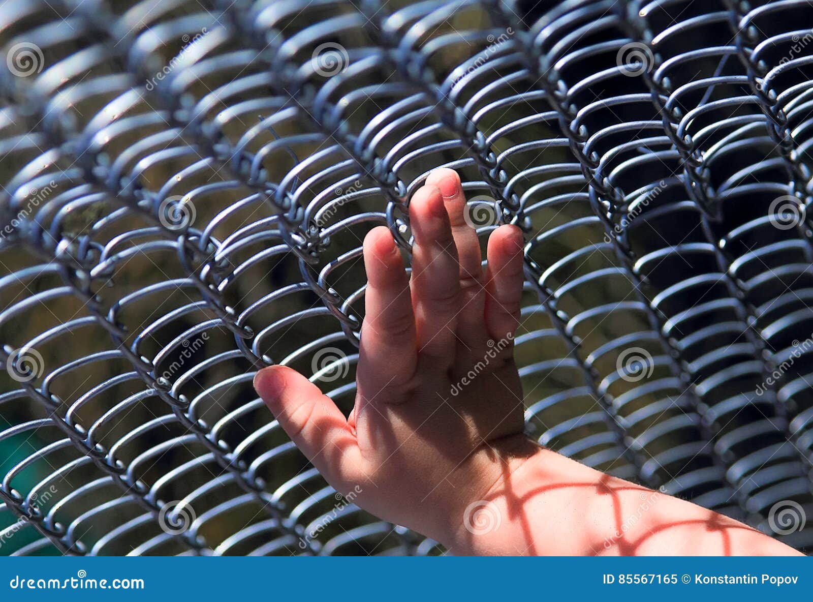 A child s hand on the grid stock image. Image of jail - 85567165